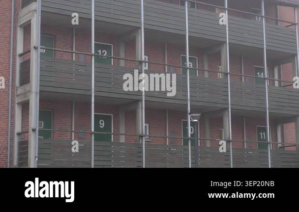 Residential building with balconies and floor numbering in urban ...