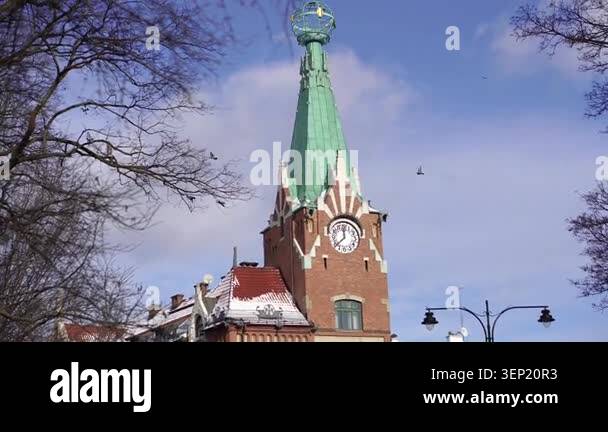 Historic building with tower and clock in cityscape with birds Stock ...