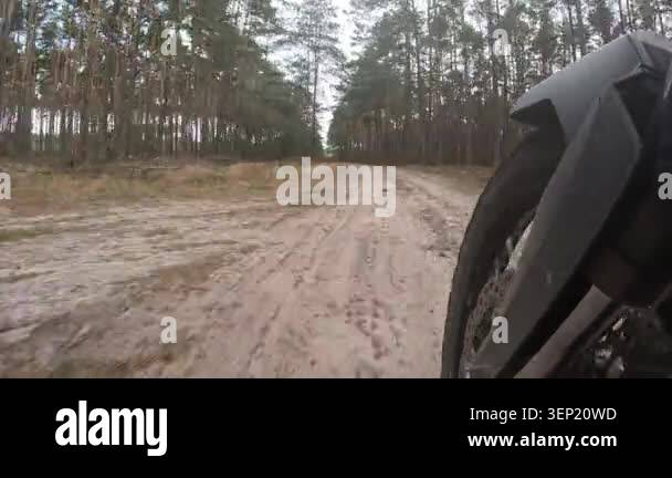 Offroad Motorcycle driving on sandy forrestroad. High quality 4k ...