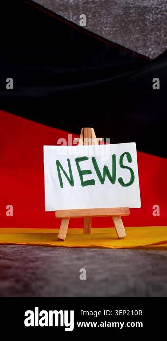 Paper note with words NEWS on National symbol of Germany. German wave ...