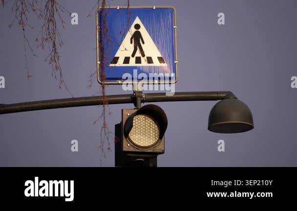 Pedestrian sign and traffic light on city street during daytime Stock ...