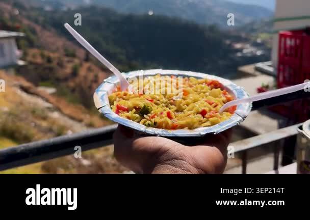 hot vegetable maggi noodles served with scenic mountain valley view in ...