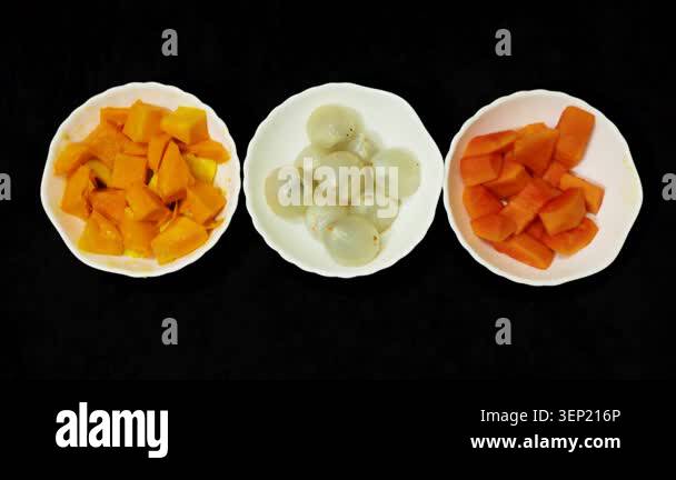 assorted tropical fruit bowls with mango lychee and papaya on black ...