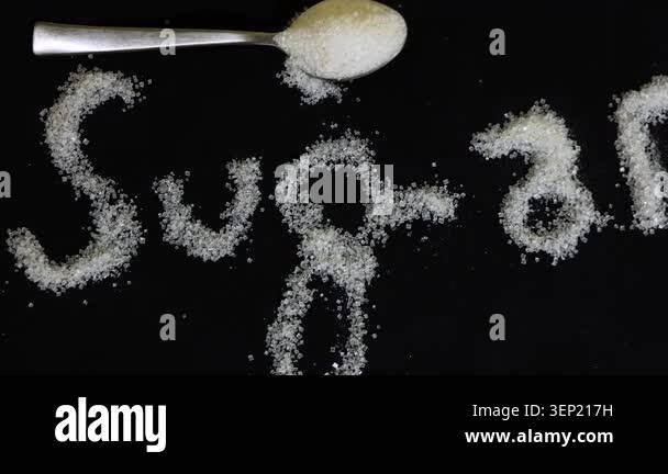 close up of sugar crystals spelling sugar for health and dietary ...