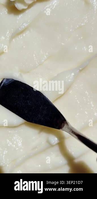 Close-up macro view of thick cream hair mask texture being swatched and ...