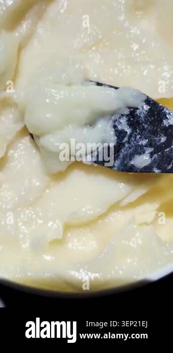 Close-up macro view of thick cream hair mask texture being swatched and ...