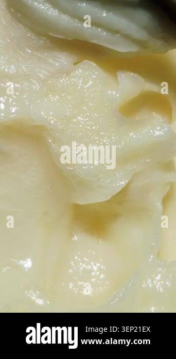 Close-up macro view of thick cream hair mask texture being swatched and ...