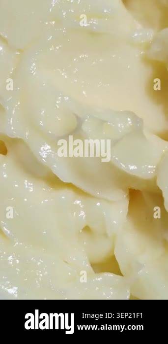 Close-up macro view of thick cream hair mask texture being swatched and ...