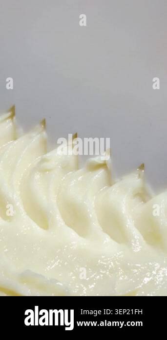 Close-up macro view of thick cream hair mask texture being swatched and ...