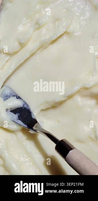 Close-up macro view of thick cream hair mask texture being swatched and ...