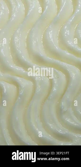Close-up macro view of thick cream hair mask texture being swatched and ...