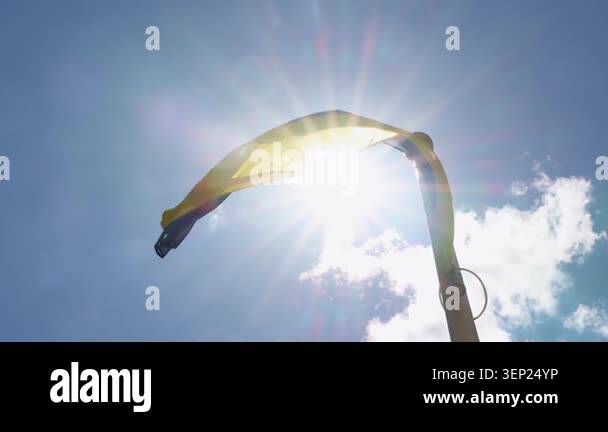 Ukrainian flag waving on flagpole against blue sky and bright sun Stock ...