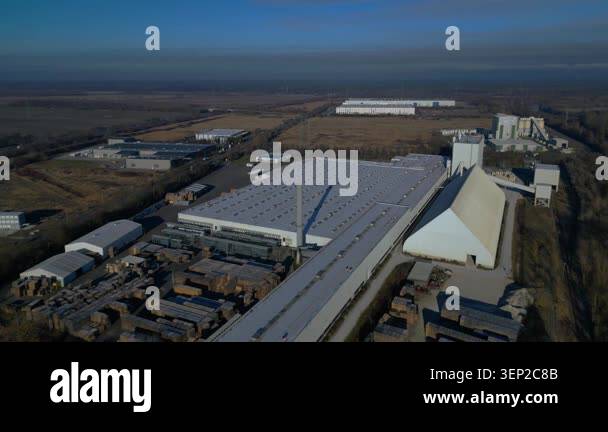 Large industrial complex featuring multiple factory buildings, material ...