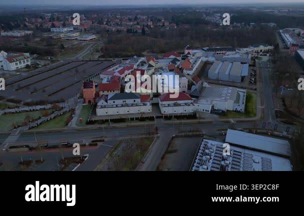 Aerial view capturing a large shopping outlet center with multiple ...