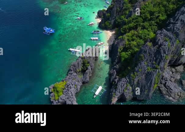 People enjoying a tropical vacation, swimming in clear turquoise water ...