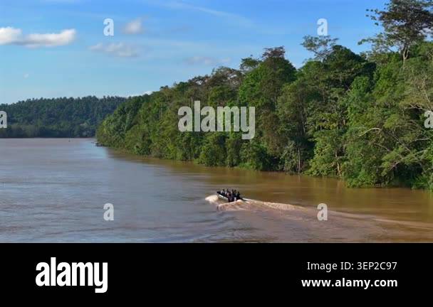 A Tourist Motor Boat Sailing by Large Brown River in Tropical ...