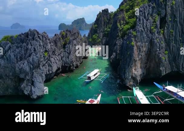 People enjoying a tropical vacation, swimming in clear turquoise water ...