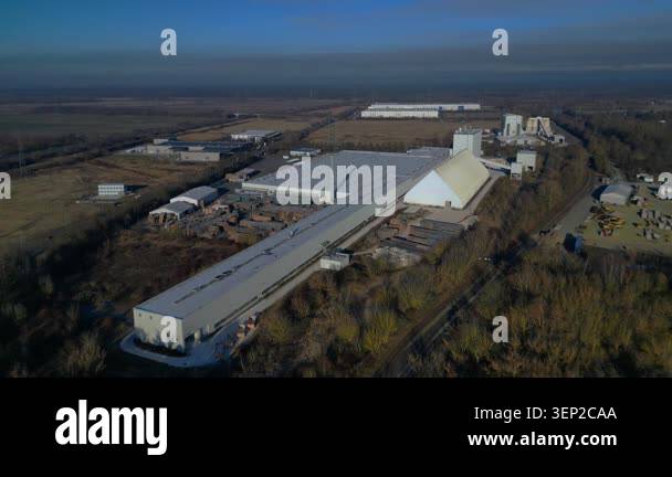 Large industrial complex featuring multiple factory buildings, material ...