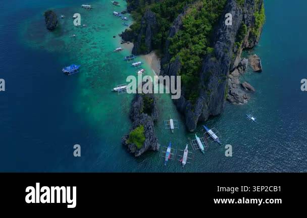 People enjoying a tropical vacation, swimming in clear turquoise water ...