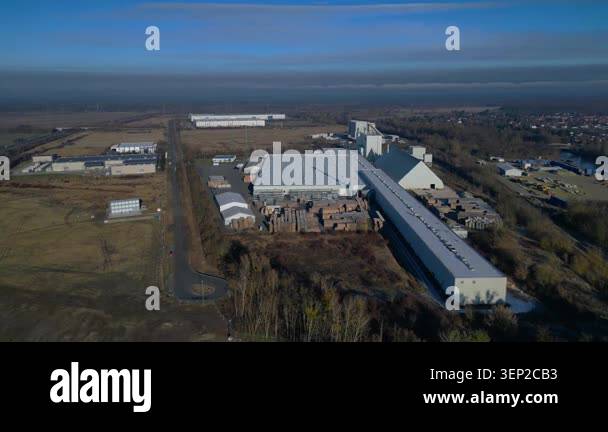 Large industrial complex featuring multiple factory buildings, material ...
