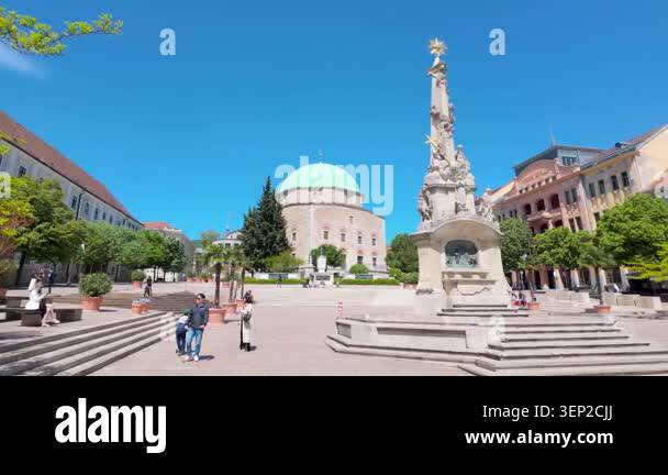 Pecs, Hungary May 1, 2026: Panoramic city square scene featuring the ...