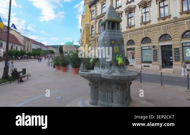Pecs, Hungary May 1, 2026: Decorative historic fountain surrounded by ...
