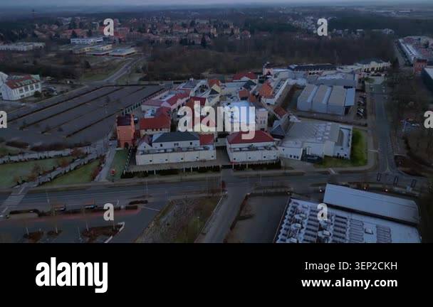 Aerial view capturing a large shopping outlet center with multiple ...