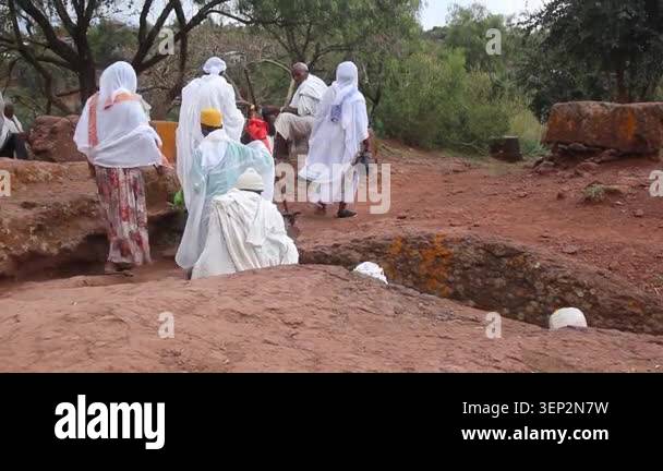 LALIBELA, ETHIOPIA - MARCH 29, 2019: People climbing from Saint George ...