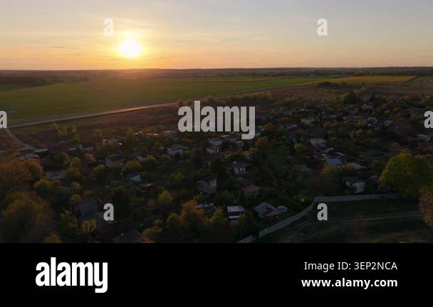 Aerial drone view of recreational garden plots with small cottages and ...