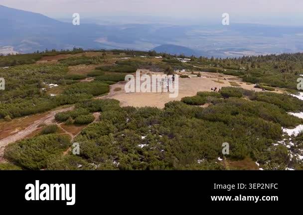 Aerial drone view of Pilsko mountain summit with hikers and snow ...