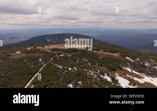 Aerial drone view of Pilsko mountain summit with hikers and snow ...