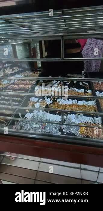 First-person video of Glass display case holds neatly arranged gold ...