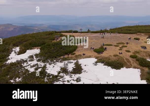 Aerial drone view of Pilsko mountain summit with hikers and snow ...