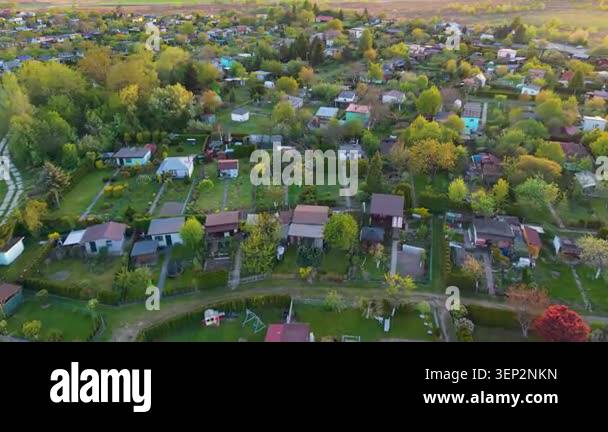 Aerial drone view of recreational garden plots with small cottages and ...
