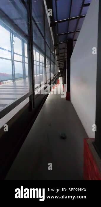First-person video of Modern train station platform under glass-covered ...