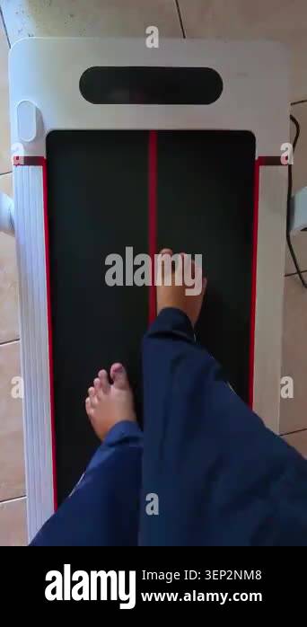 4K Vertical Videos Feet step on treadmill's moving belt. Person wears ...