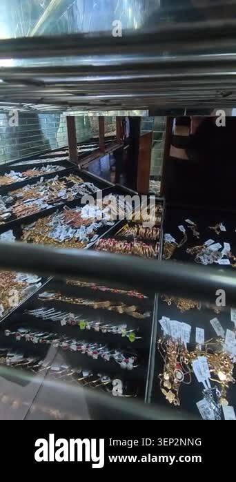 First-person video of Glass display case holds neatly arranged gold ...