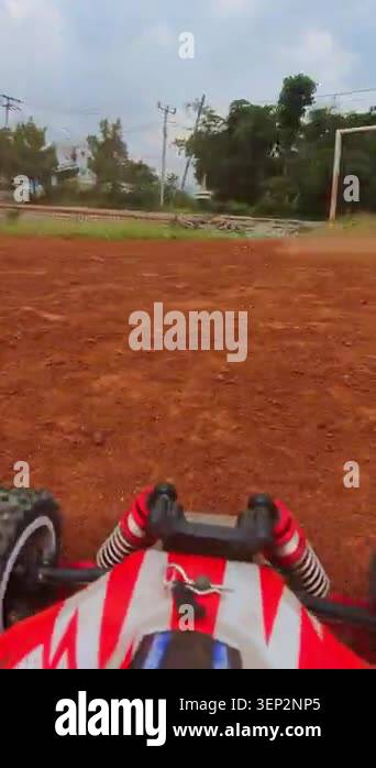 4K Vertical Video of Buggy RC Car racing on dirt ground. Dust swirls ...