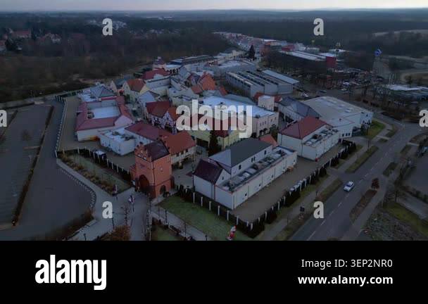 Aerial view capturing a large shopping outlet center with multiple ...