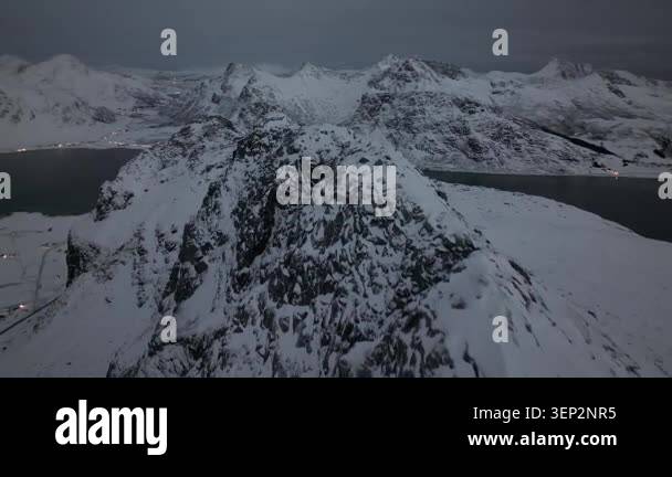 High-altitude aerial view of a rugged snow-covered mountain ridge in ...