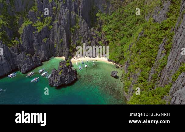 Secret lagoon hidden by towering limestone cliffs, clear turquoise ...