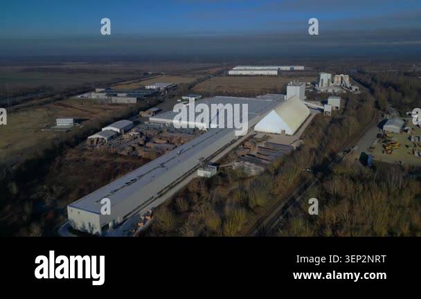 Large industrial complex featuring multiple factory buildings, material ...