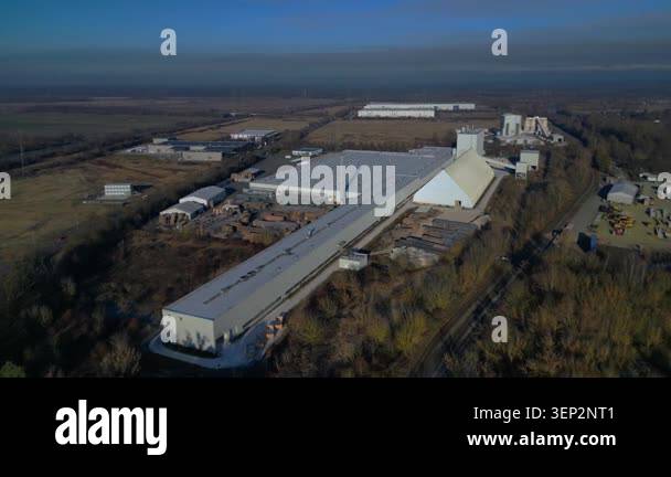 Large industrial complex featuring multiple factory buildings, material ...