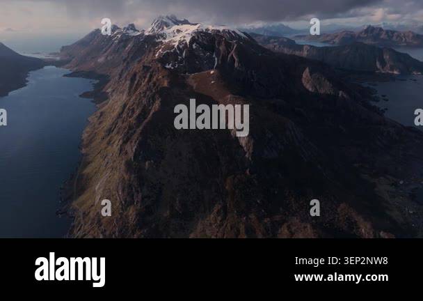 High aerial perspective of a rugged coastal mountain range with snow ...