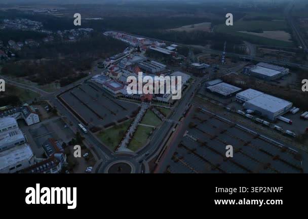 Aerial view of an outlet shopping center with empty parking lots ...