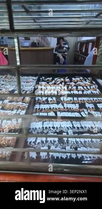 First-person video of Glass display case holds neatly arranged gold ...