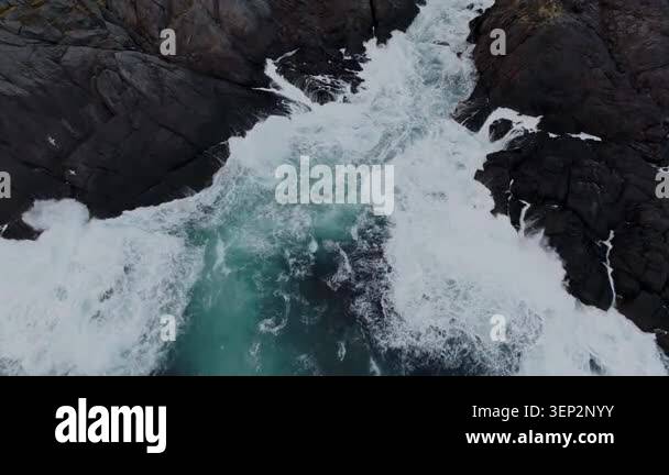 Top-down aerial view showing powerful ocean waves breaking into jagged ...