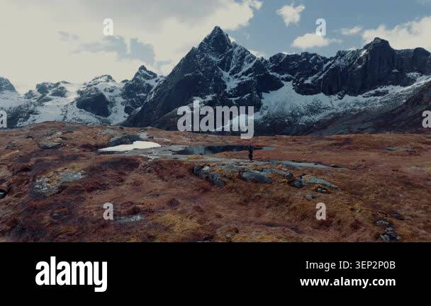 Wide landscape showing a dark triangular mountain peak rising above ...