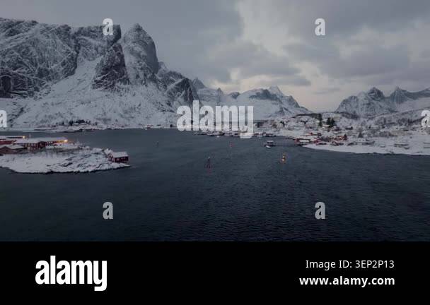 High aerial perspective of a small coastal fishing village nestled ...