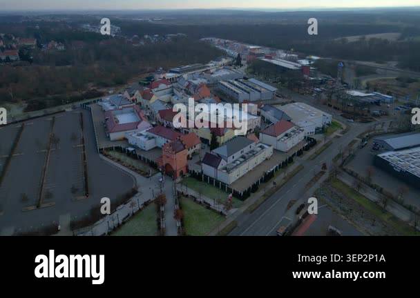 Aerial view capturing a large shopping outlet center with multiple ...